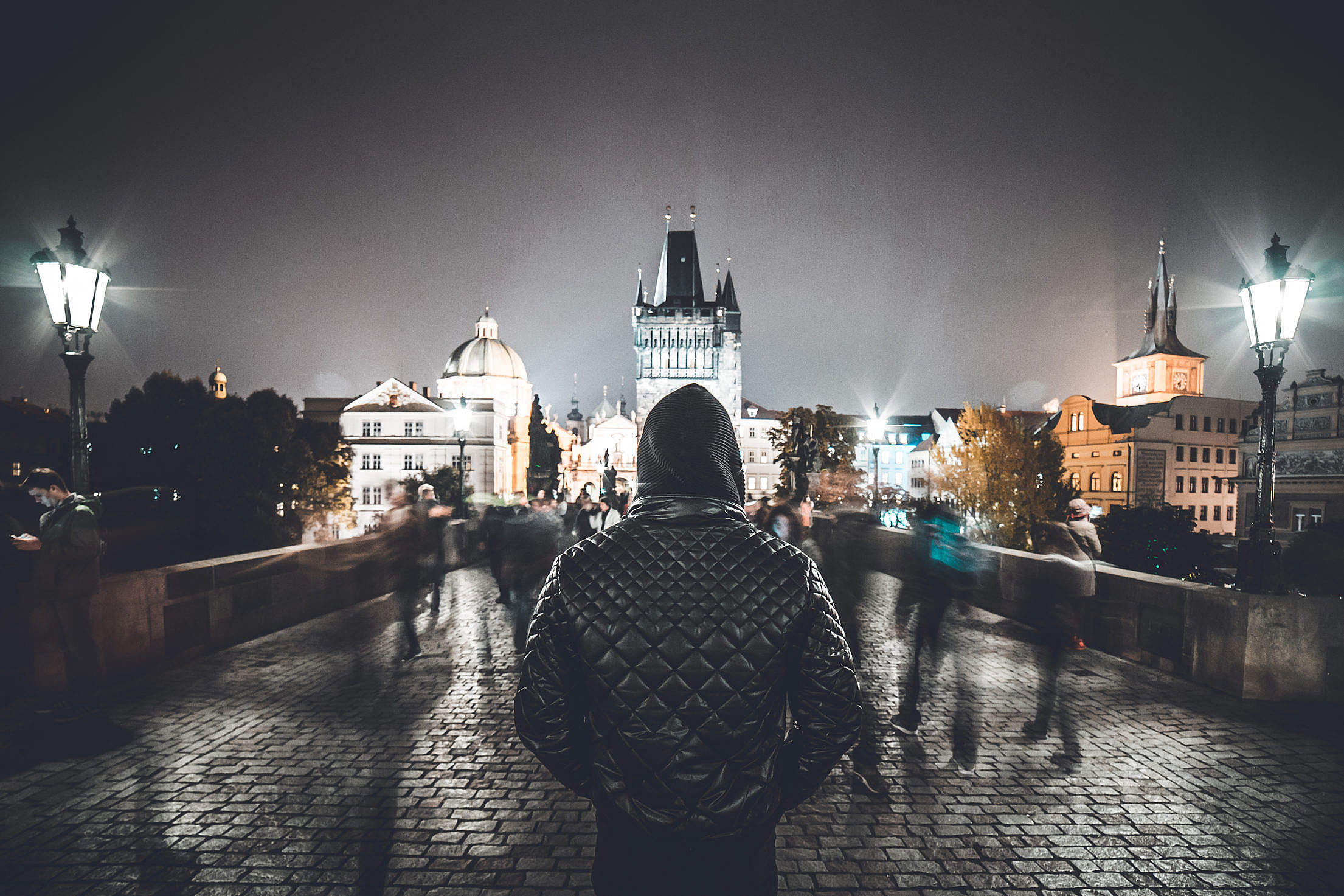 Man in a Hoodie Standing Still Against Crowds on Charles Bridge, Prague ...