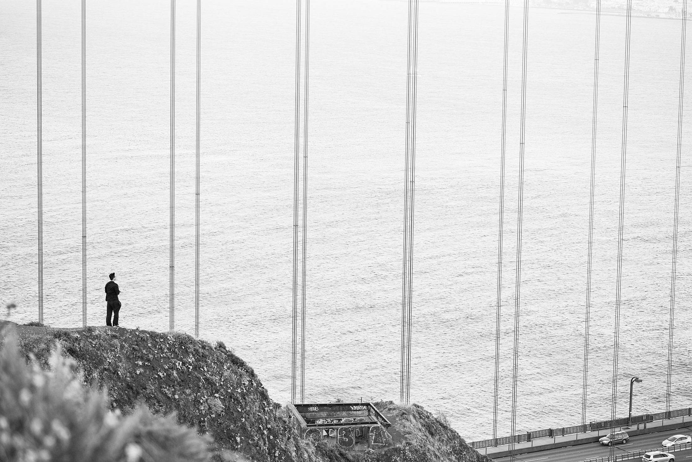 Man Stands at The Edge of The Cliff Near The Golden Gate Bridge Free ...