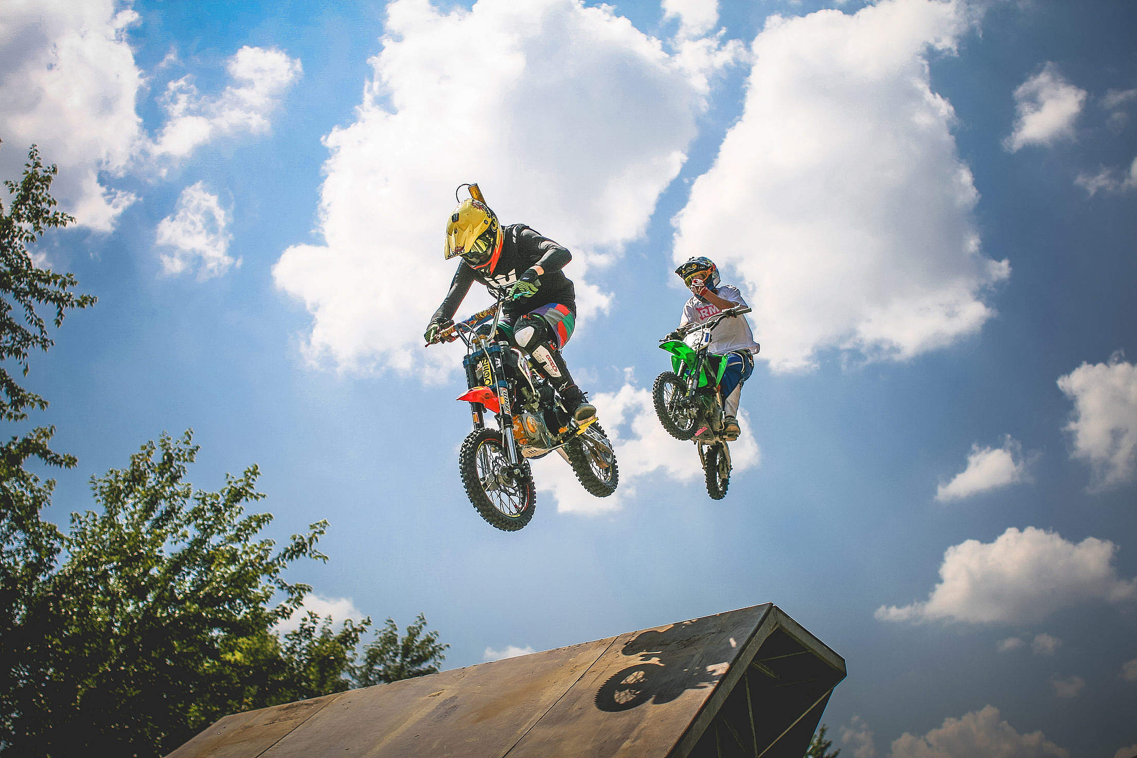 Two Crazy Jumping Pitbikers Free Stock Photo | picjumbo